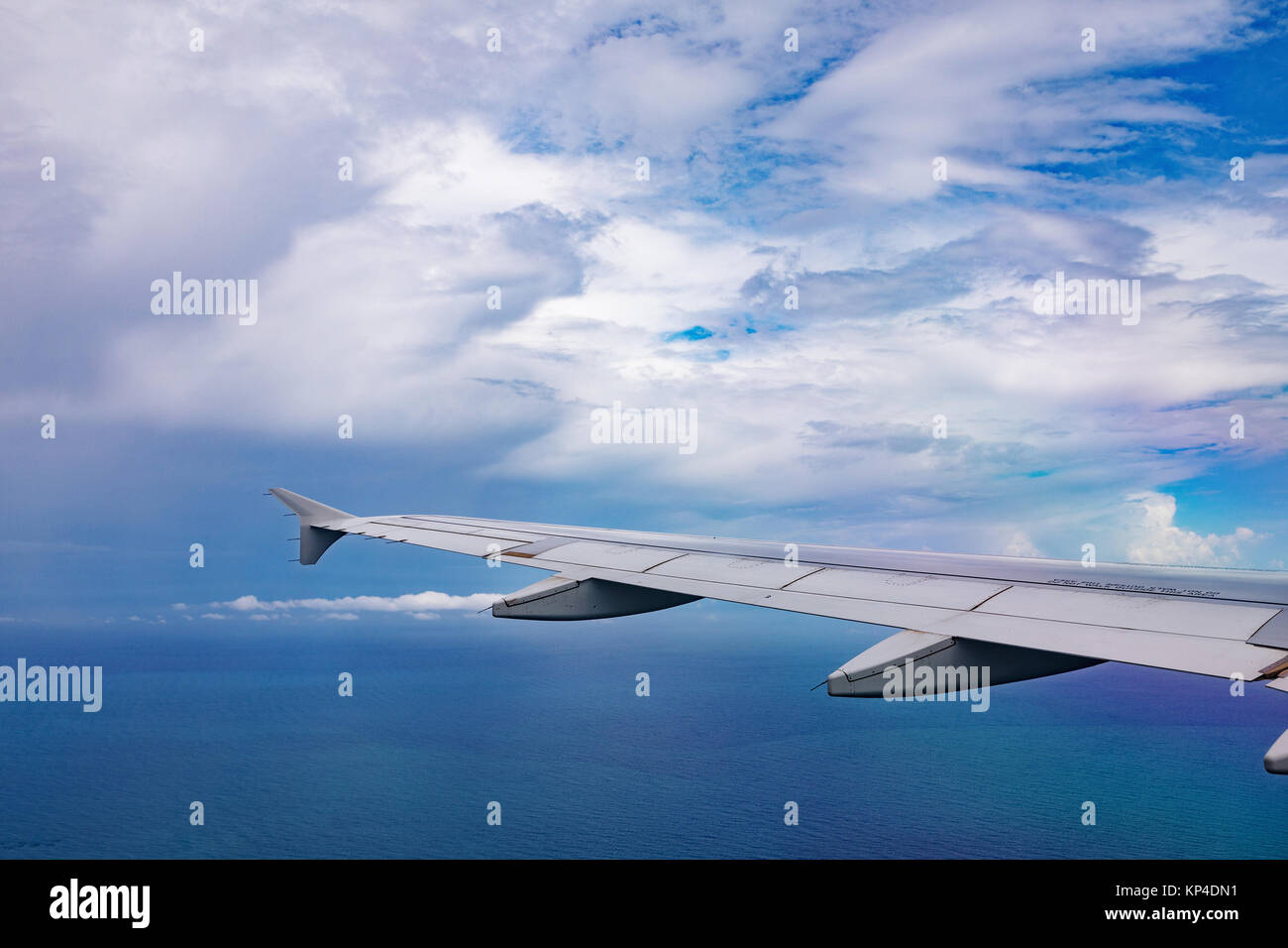 Wing of aeroplane over ocean island hi-res stock photography and images ...