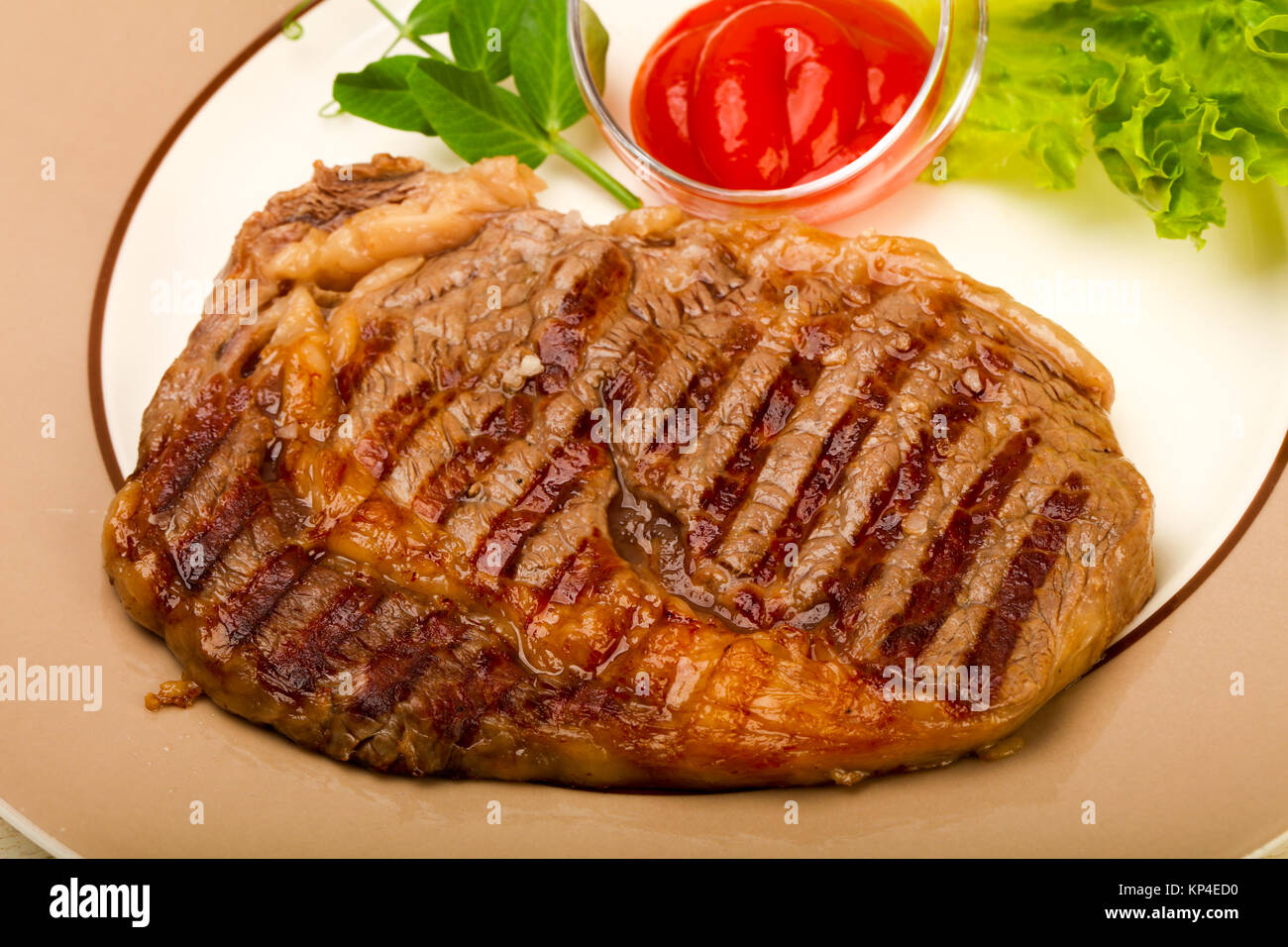 Grilled Rib eye steak with sauce Stock Photo - Alamy