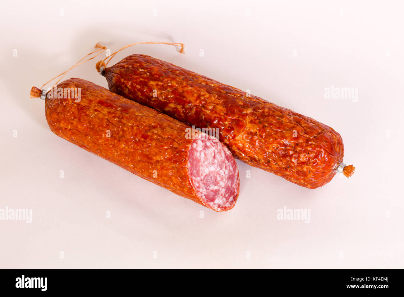 Two Salamy sausages isolated Stock Photo - Alamy
