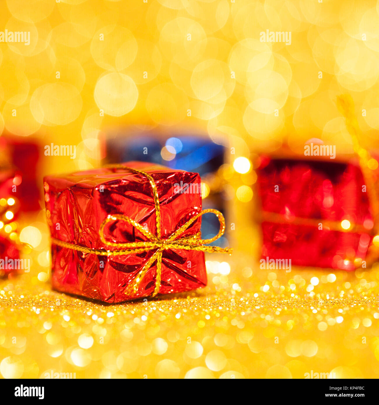 Red decorative box with holiday gift on gold glitters background Stock ...
