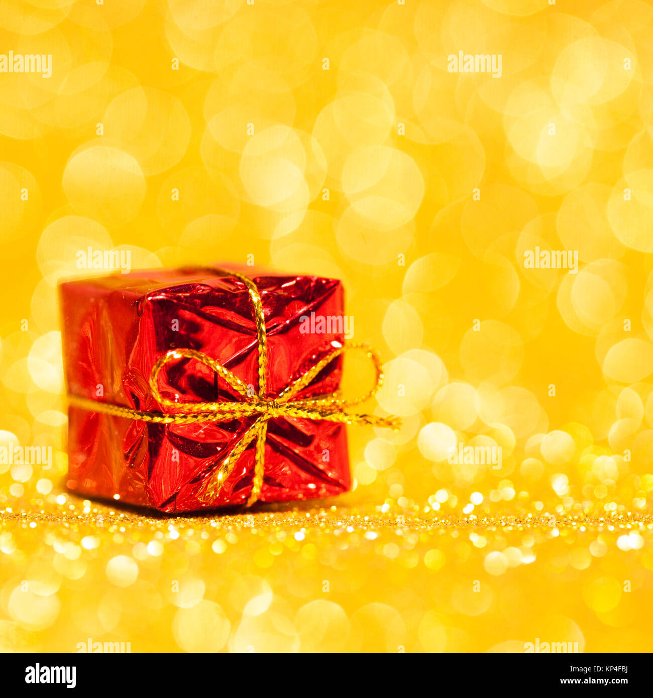 Red decorative box with holiday gift on gold glitters background Stock ...