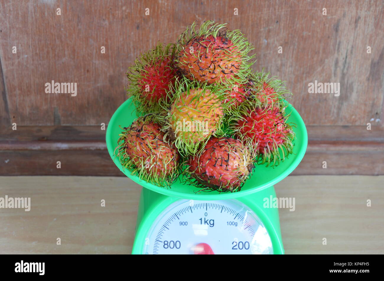 rambutan tropical on green weighing scale Stock Photo - Alamy