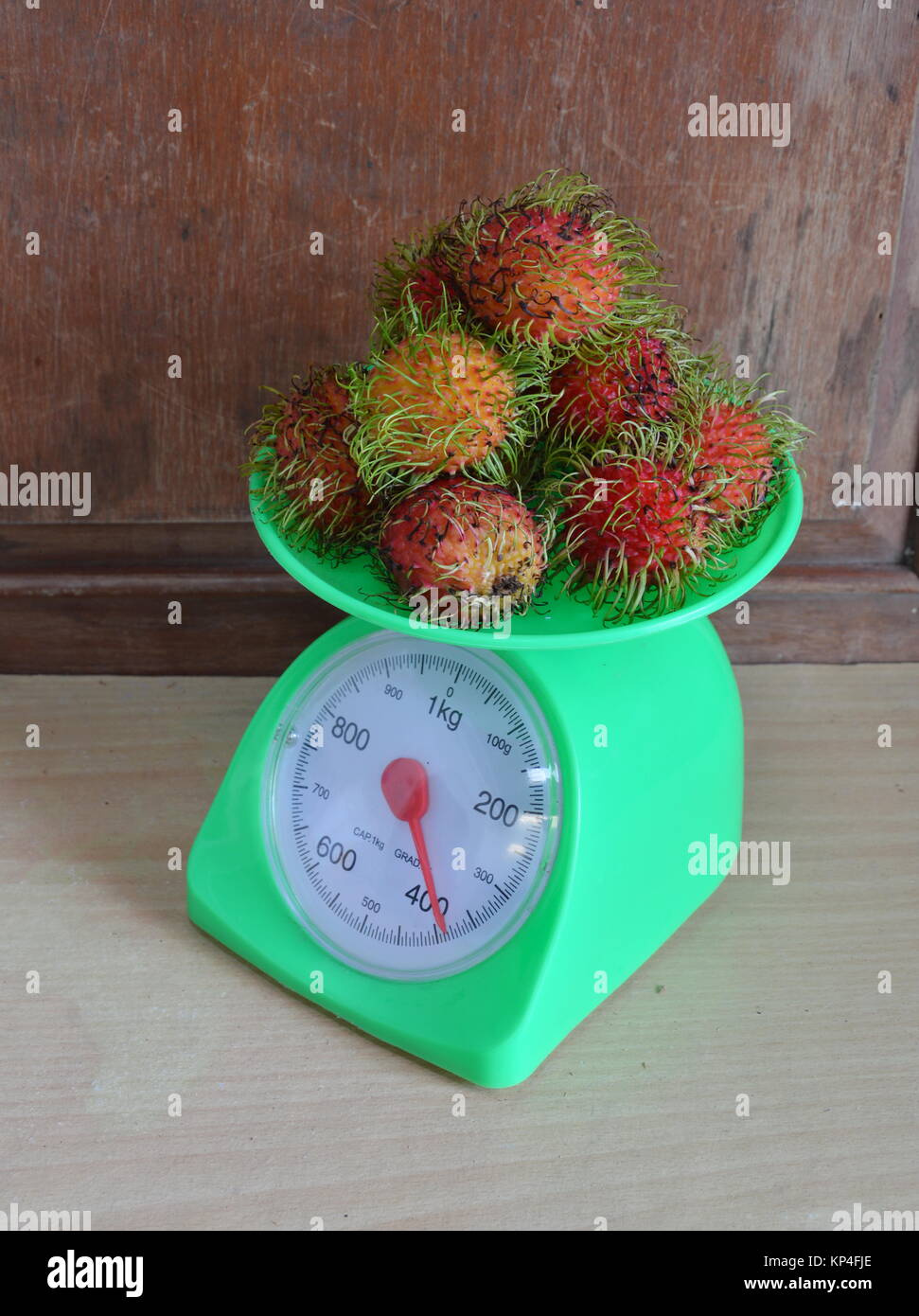rambutan tropical on green weighing scale Stock Photo - Alamy