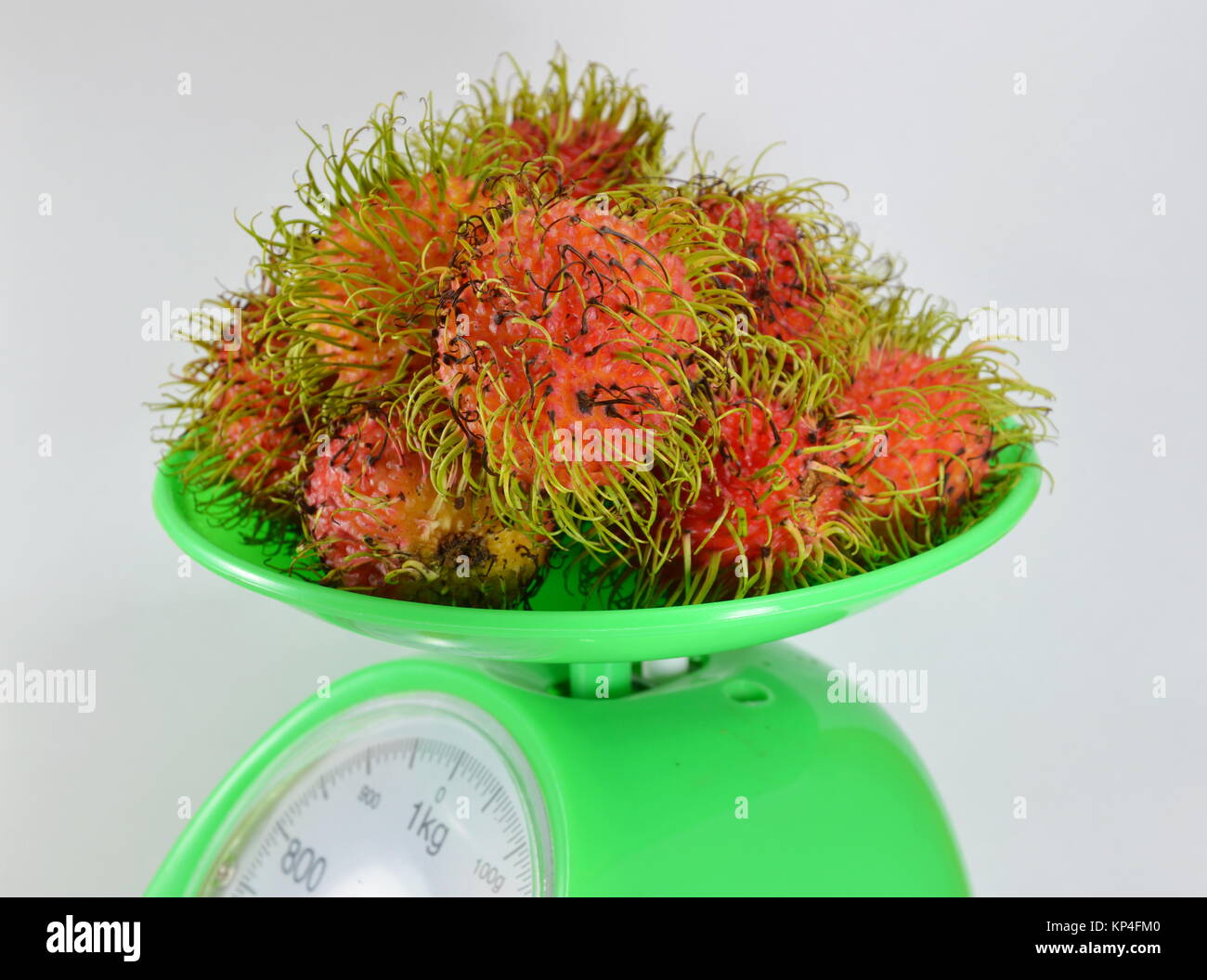 rambutan tropical on green weighing scale Stock Photo - Alamy