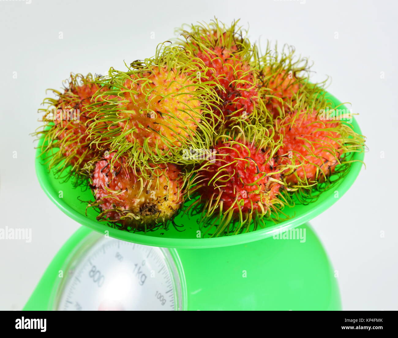 rambutan tropical on green weighing scale Stock Photo - Alamy