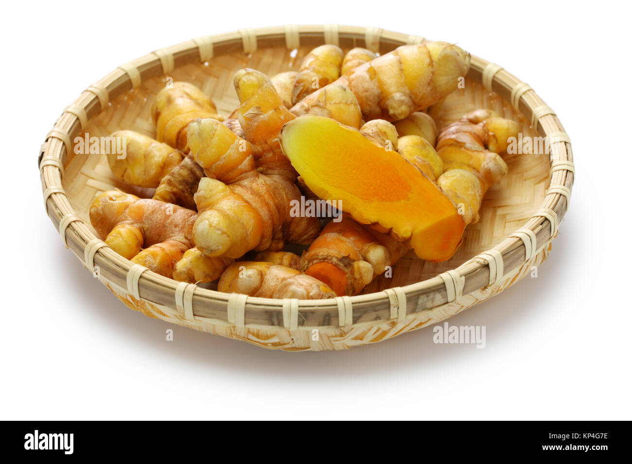 fresh whole turmeric on bamboo saucer Stock Photo - Alamy
