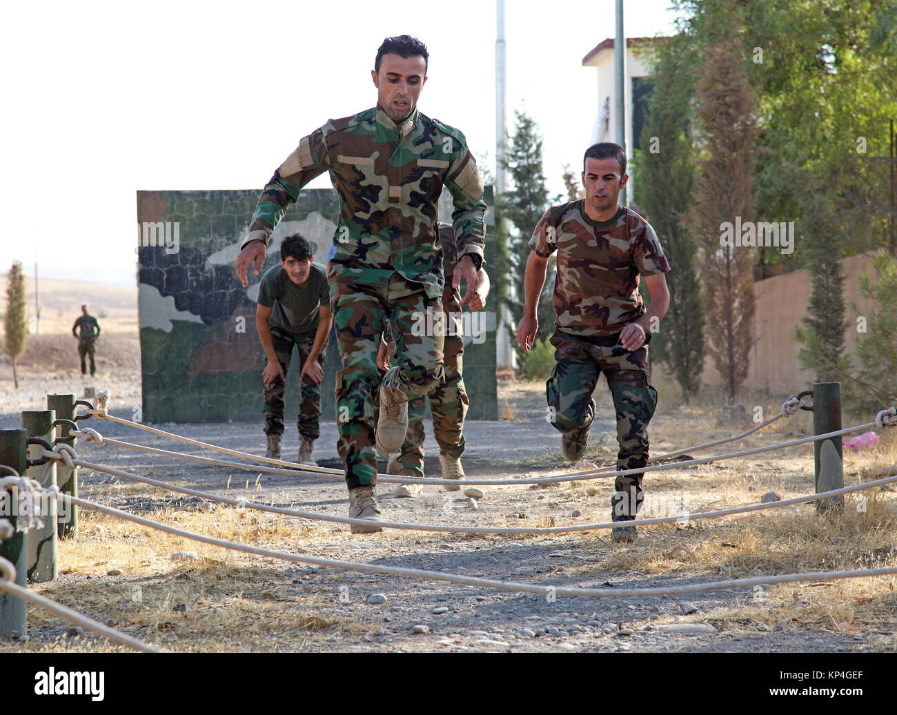 Peshmerga soldiers navigate through an obstacle course at the Kurdistan ...