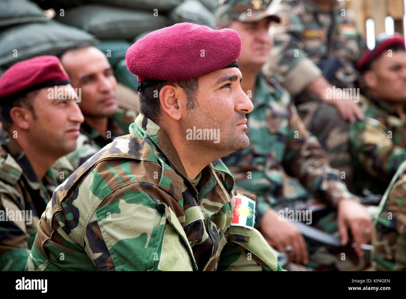 Peshmerga soldiers listen to instructions given by a British army ...