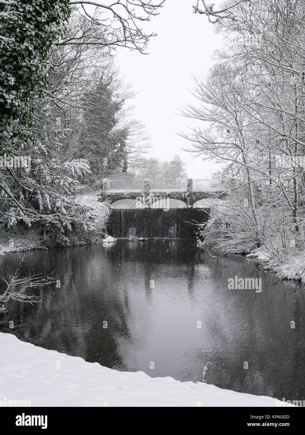 Wintry scene: Bridge over the River Dove, on a snowy day in the village ...