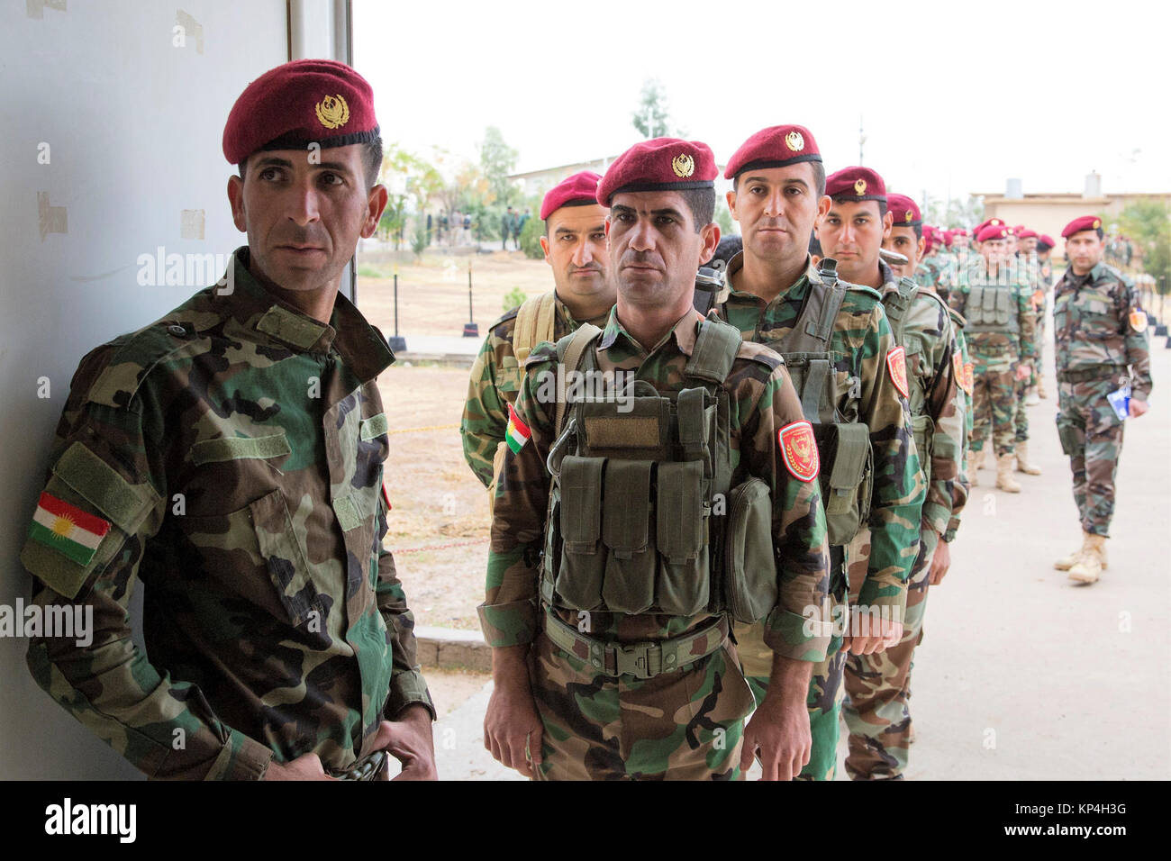 Zeravani soldiers wait in line during in processing to coalition ...