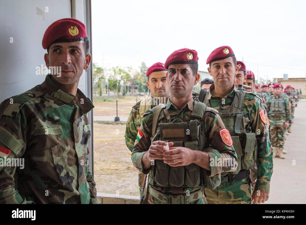 Zeravani soldiers wait in line during in processing to coalition ...