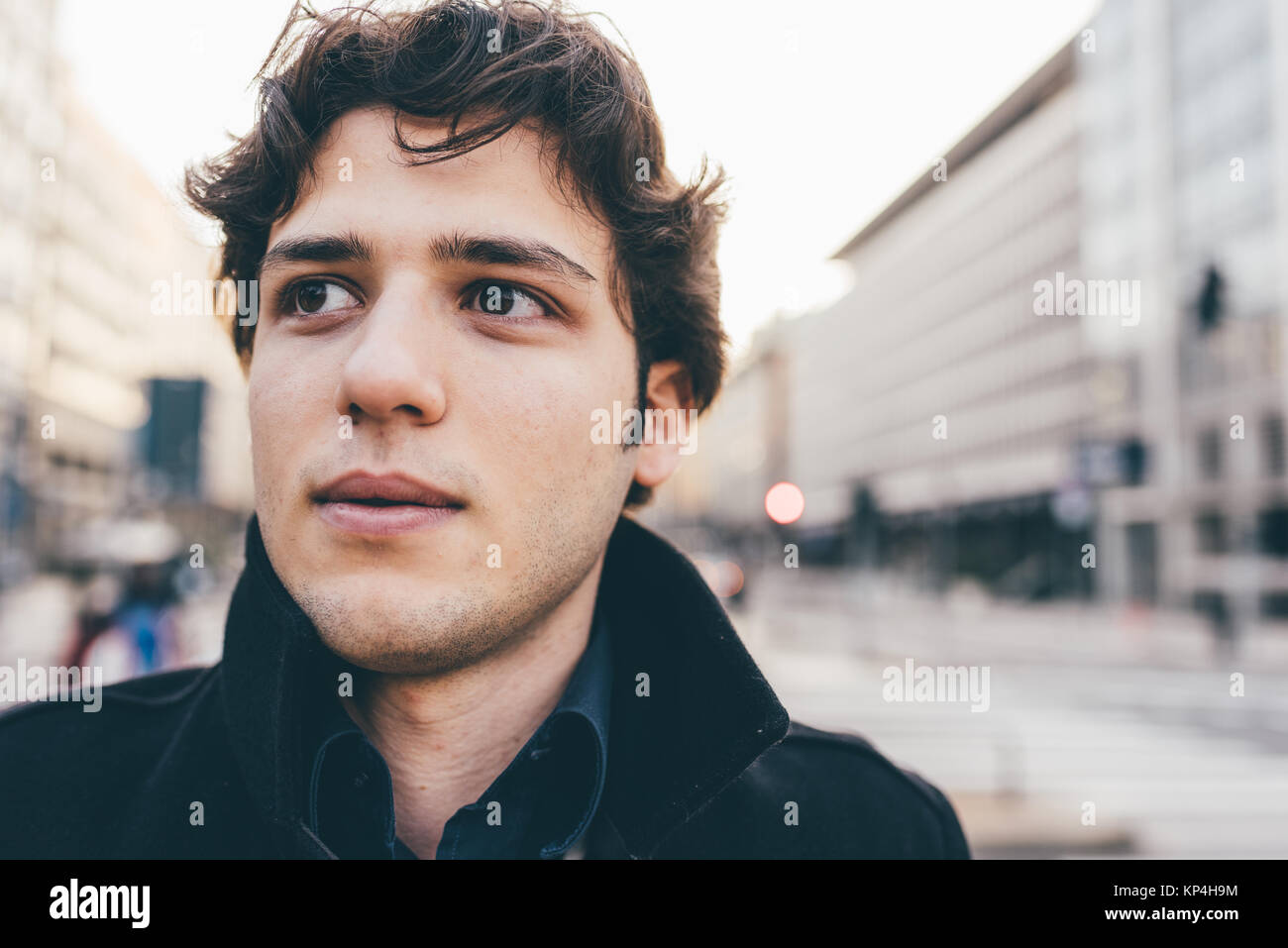 young man outdoor looking away pensive - serious, thinking concept ...