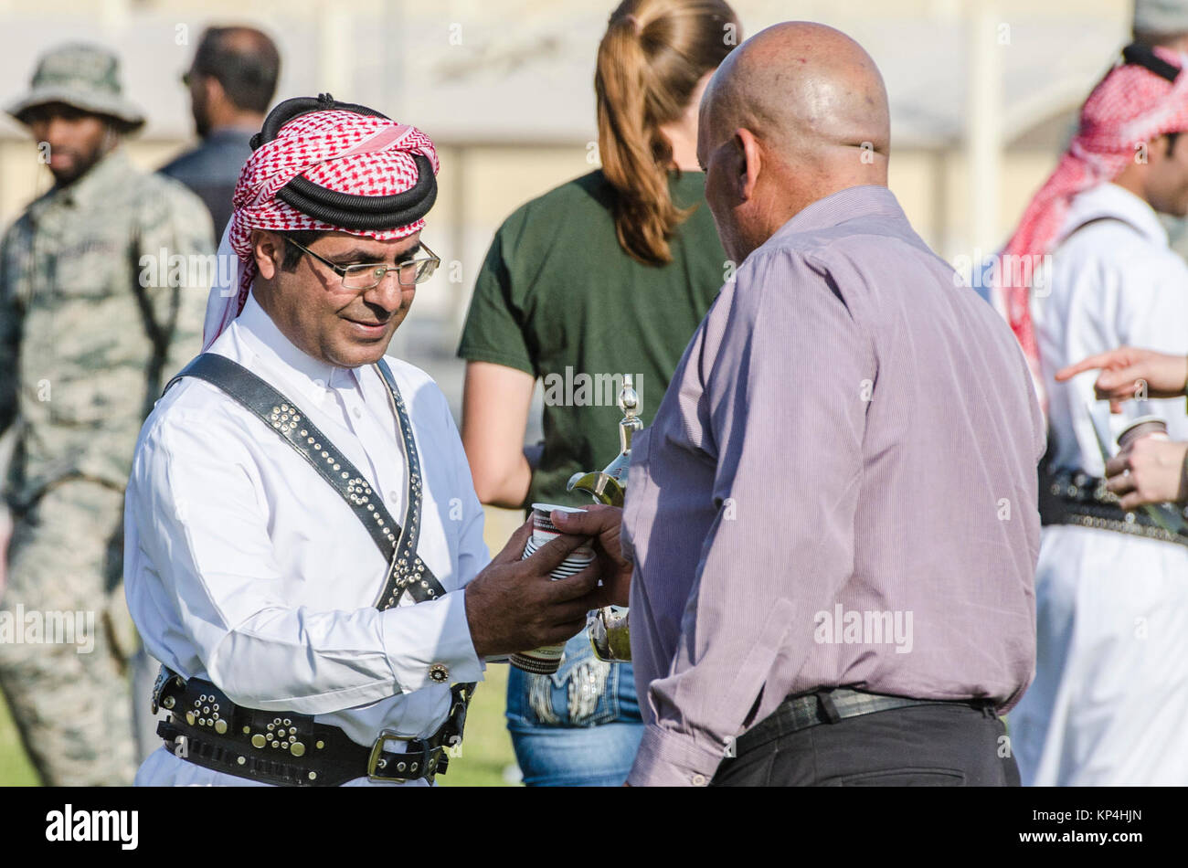 A local Qatari offers a guest a traditional cup of chai tea at the ...