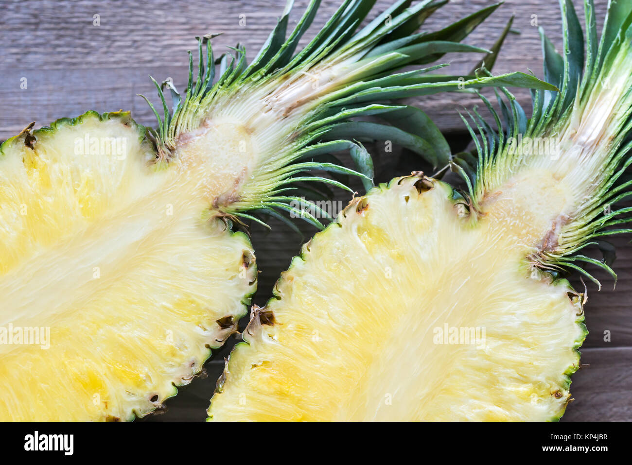 Pineapple on the wooden background: cross section Stock Photo - Alamy