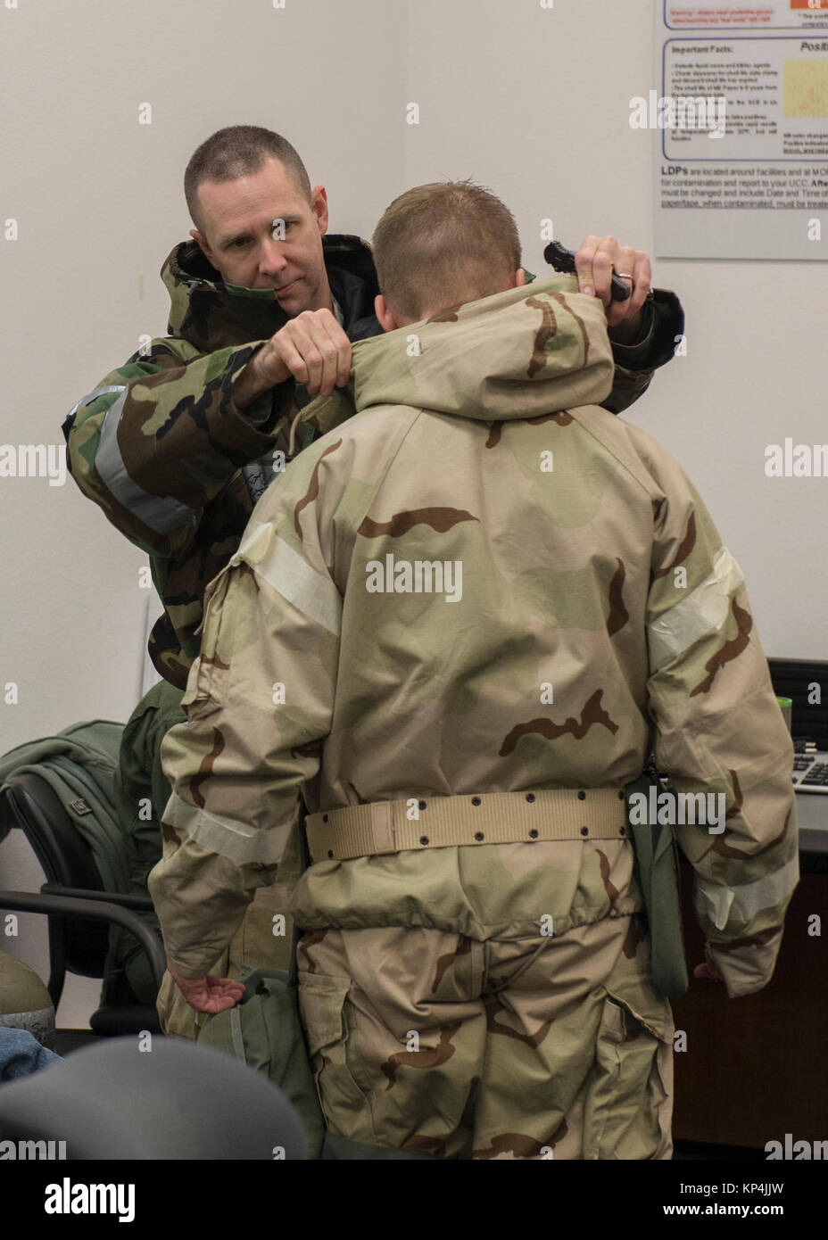 Lt. Col. Damon Scott, 366th Fighter Wing staff judge advocate, adjusts ...