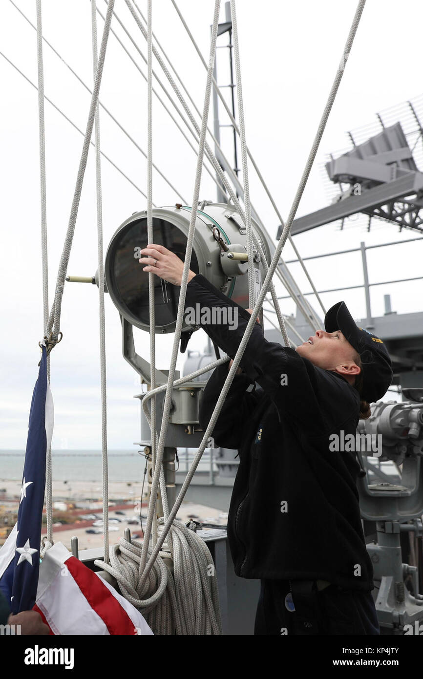 Master Chief Quartermaster Lacie Hill raises the Ensign on the signal ...