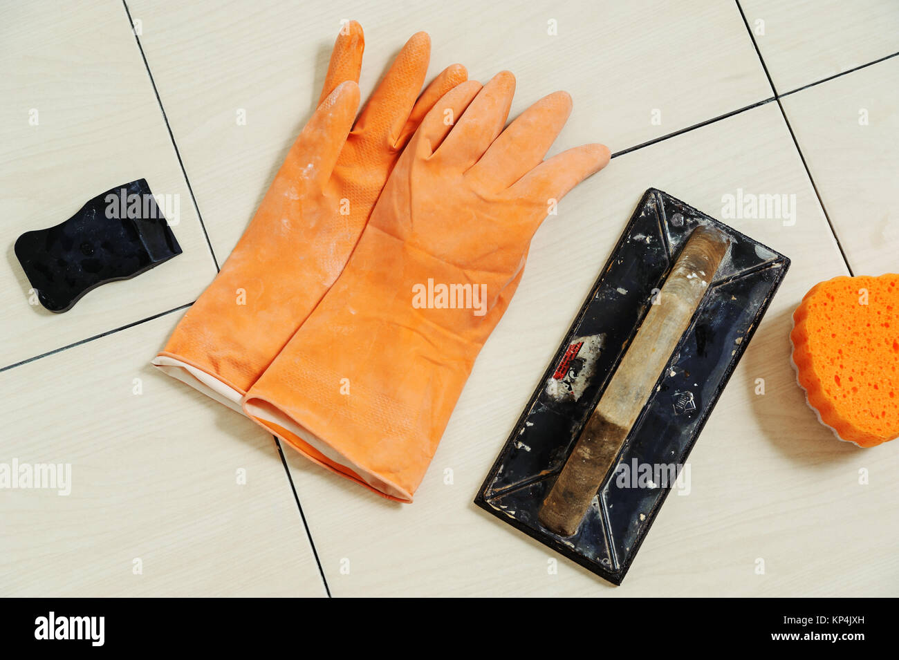 Tools for grouting on tile. Rubber spatula, rubber gloves, rubber float ...