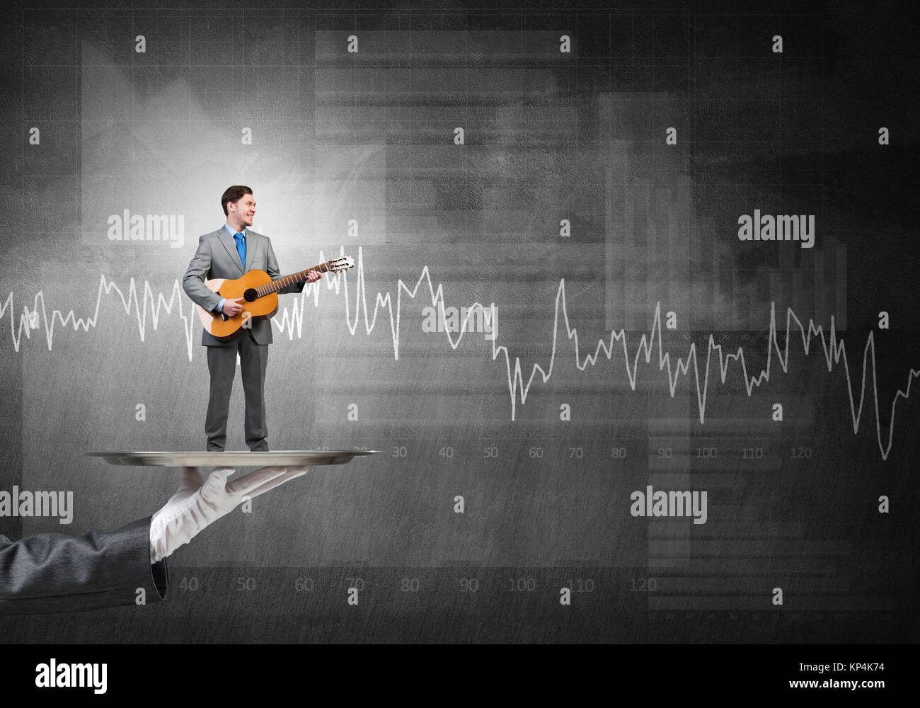 Businessman on metal tray playing acoustic guitar against graphs ...