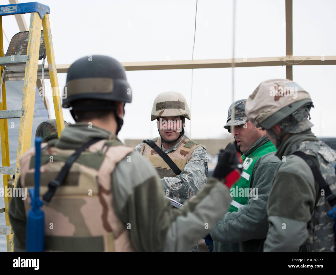A group of Airmen from the 366th Civil Engineer Squadron consult a ...
