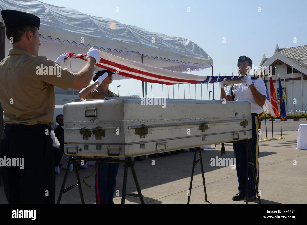 Defense POW/MIA Accounting Agency (DPAA) personnel prepare to cover a ...