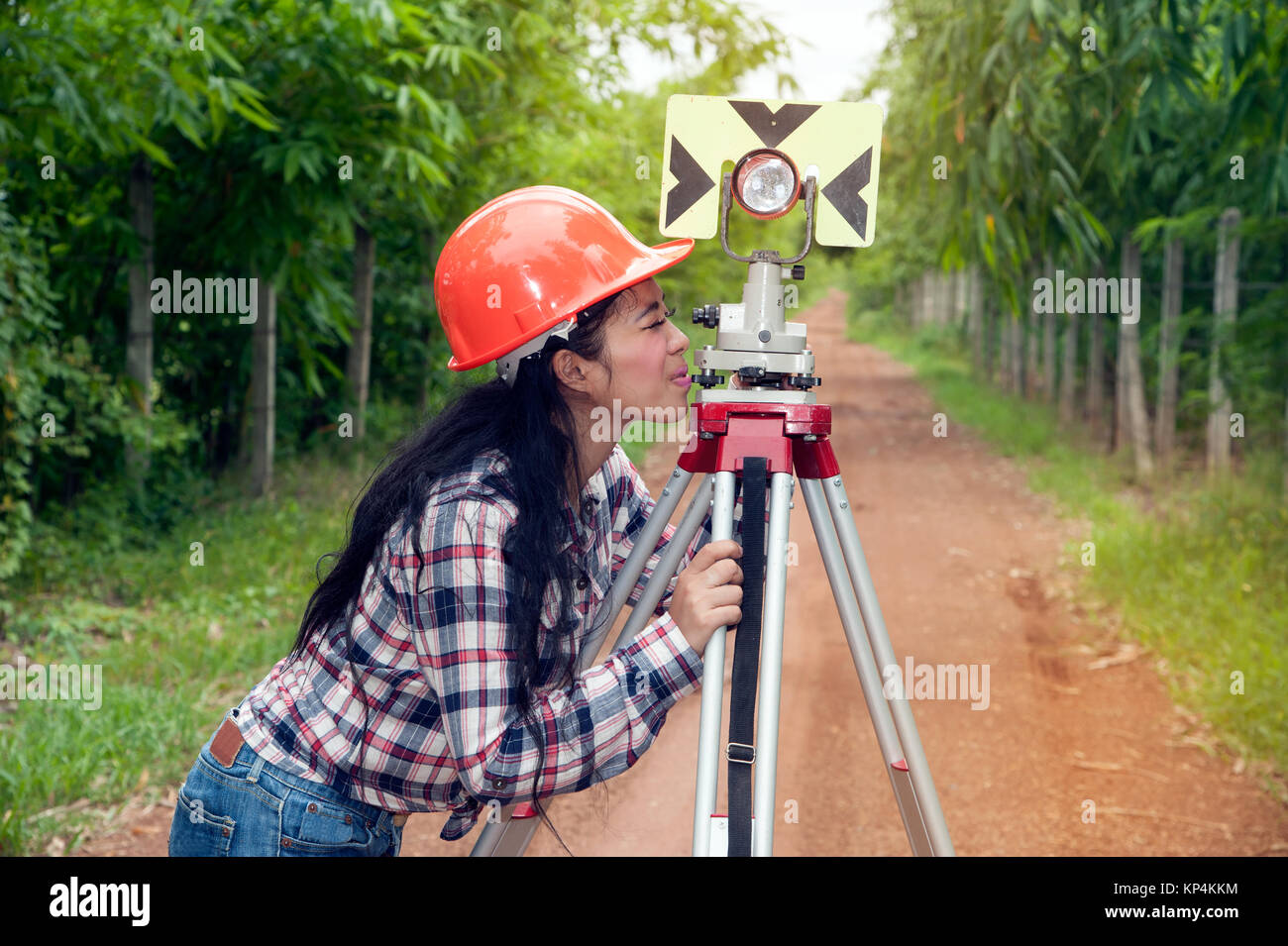 Female Surveyor or Engineer making measure by prism reflector on the ...