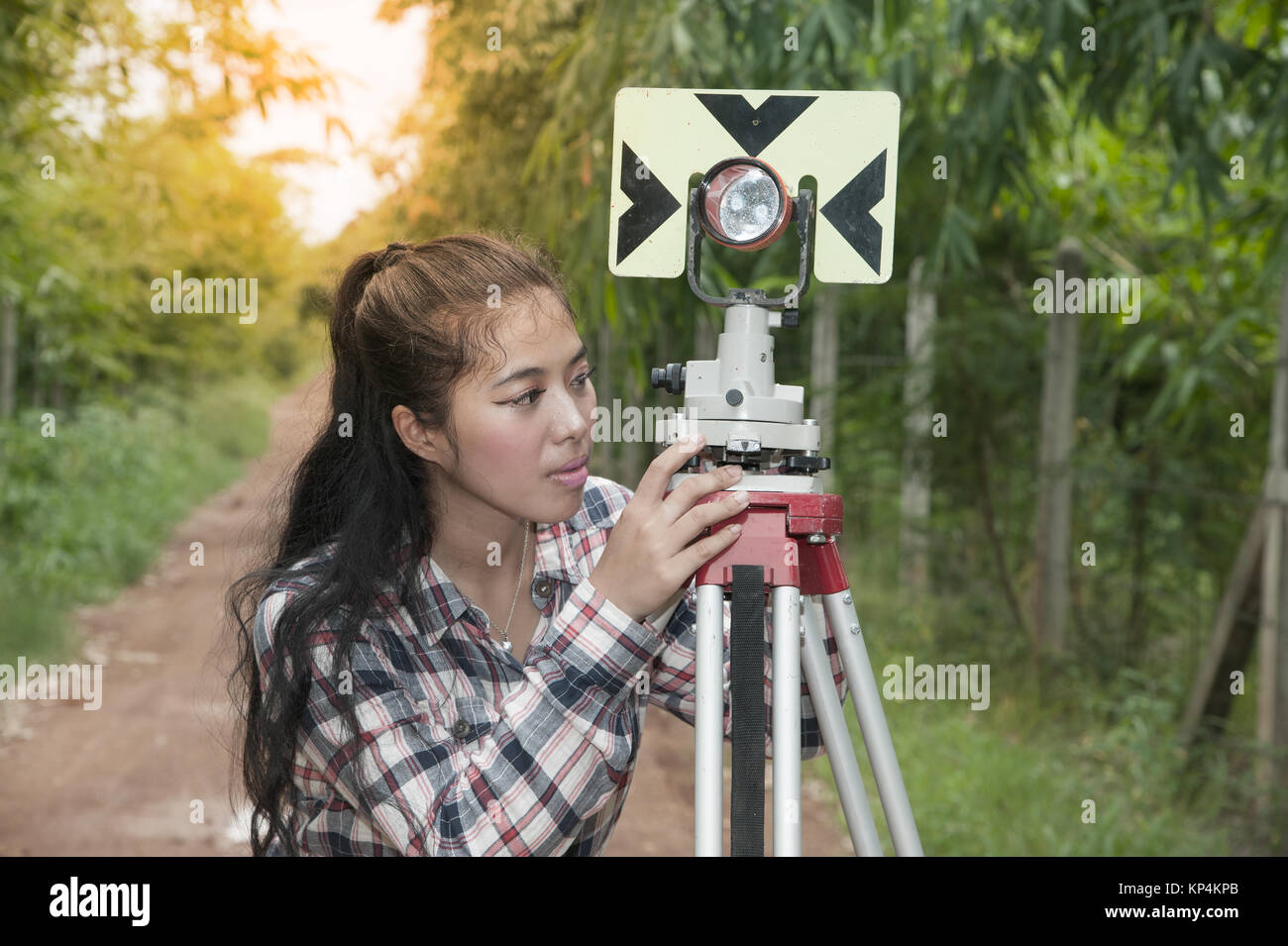 Female Surveyor or Engineer making measure by prism reflector on the ...