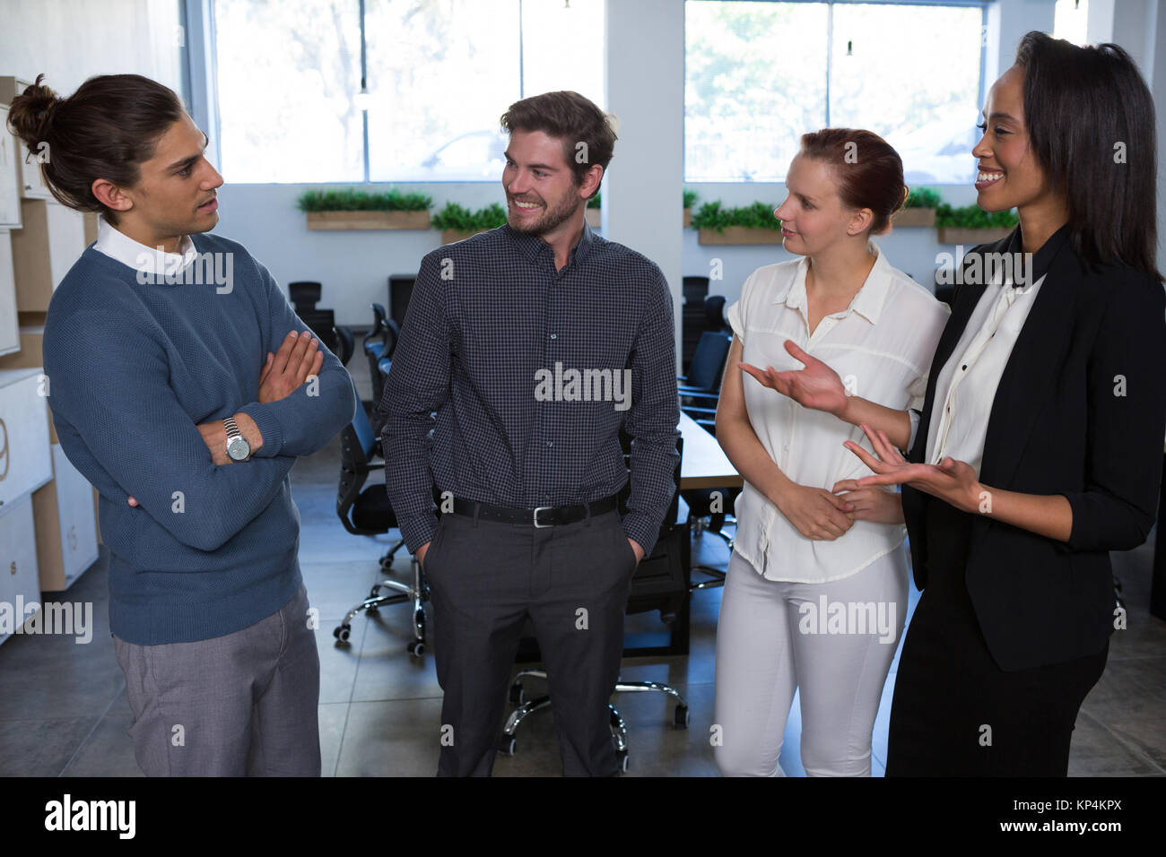Business colleagues interacting with each other in office Stock Photo ...