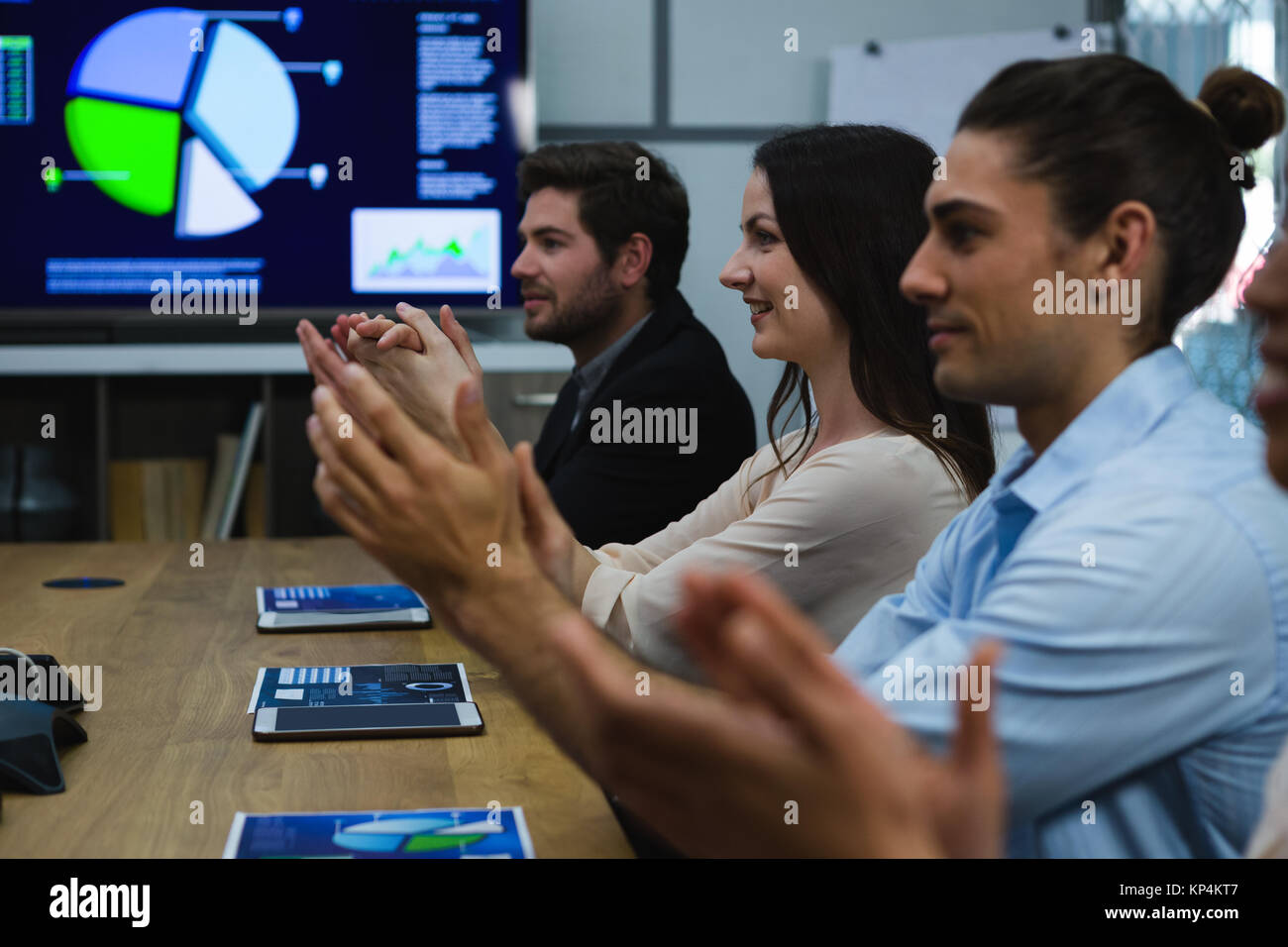 Business colleagues clapping hands in meeting at office Stock Photo - Alamy