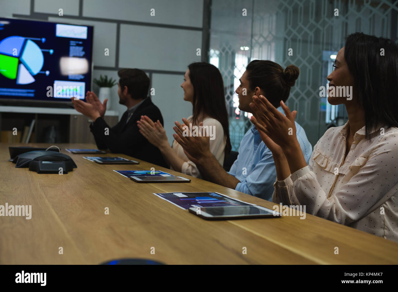 Business colleagues clapping hands in meeting at office Stock Photo - Alamy