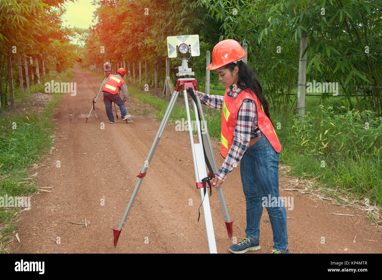 Surveyor or Engineer making measure by Theodolite with partner on the ...