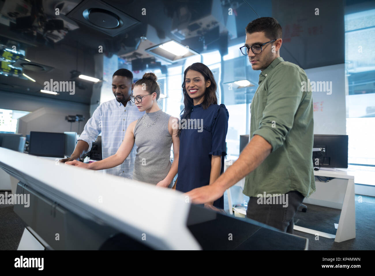 Business executives touching digital screen in futuristic office Stock ...