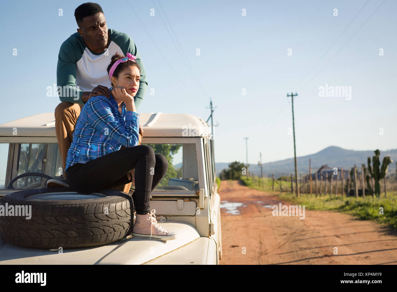 Young woman sitting on car bonnet hi-res stock photography and images ...