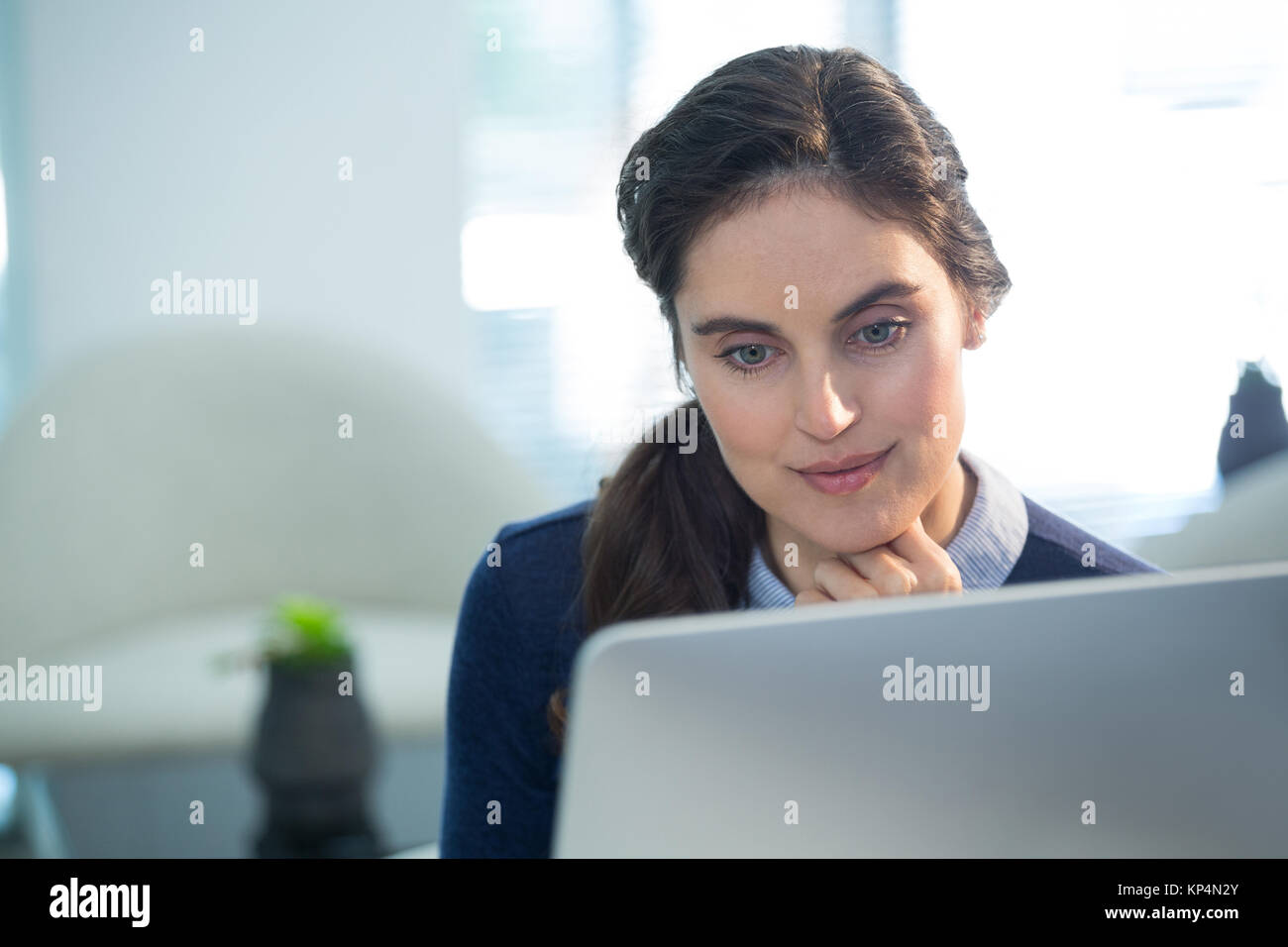 Thoughtful female executive working on computer in office Stock Photo ...