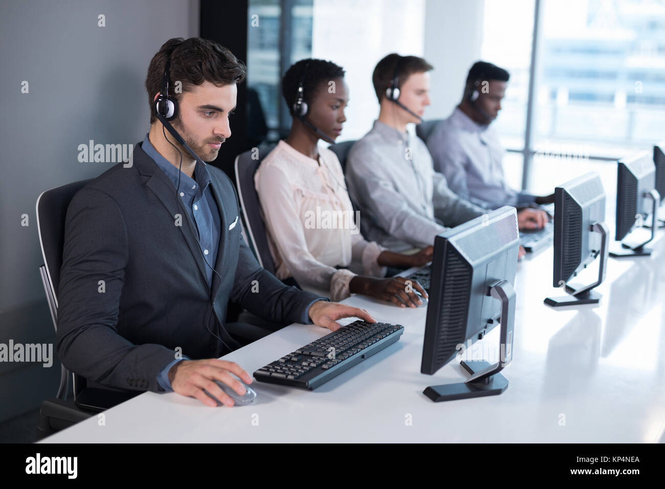 Attentive customer service executives working at office Stock Photo - Alamy