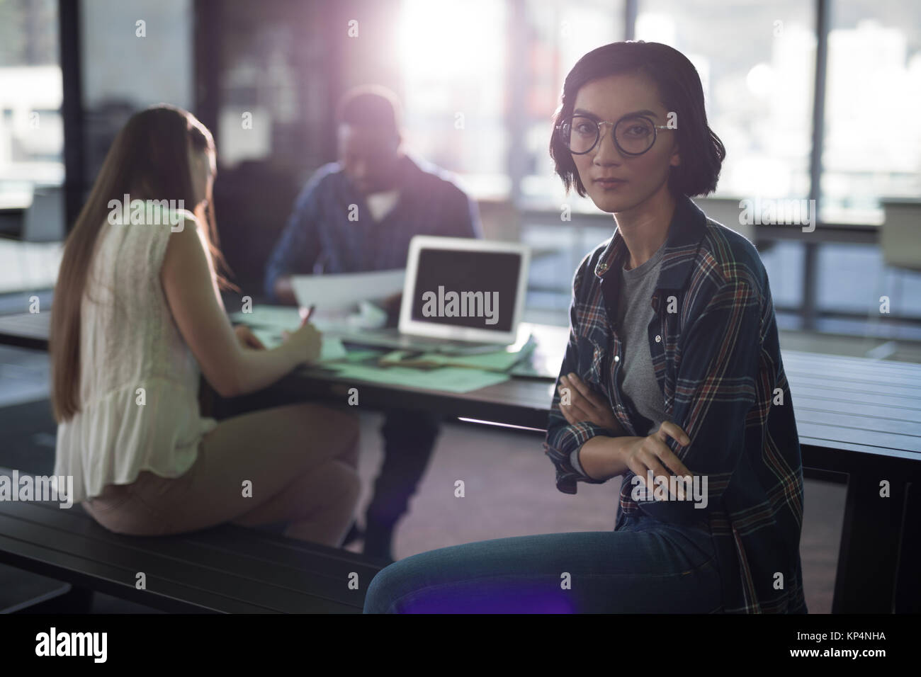 Portrait of female executive sitting in office Stock Photo - Alamy
