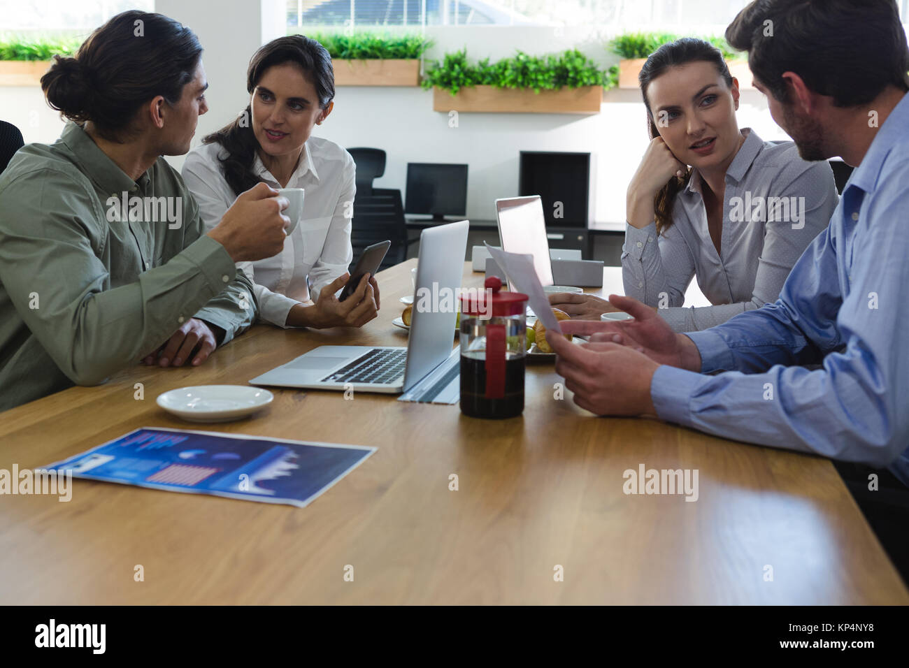 Group of executives discussing a project at desk in the office Stock ...