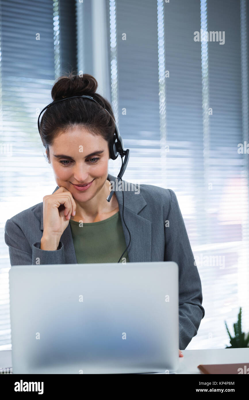 Female executive doing video call on laptop in office Stock Photo - Alamy