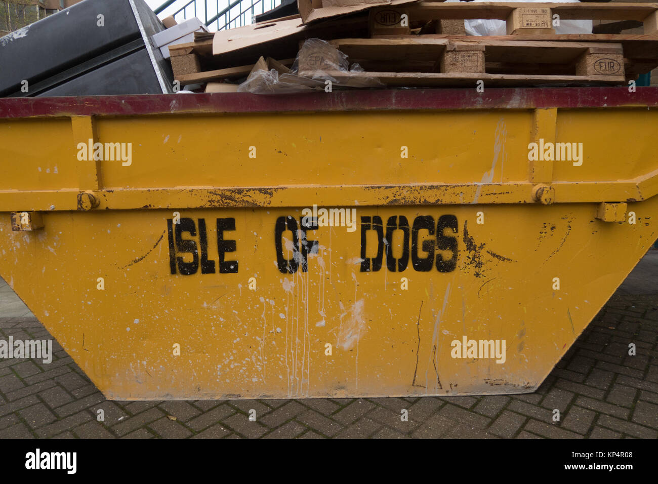 A yellow Isle of Dogs building skip Stock Photo - Alamy