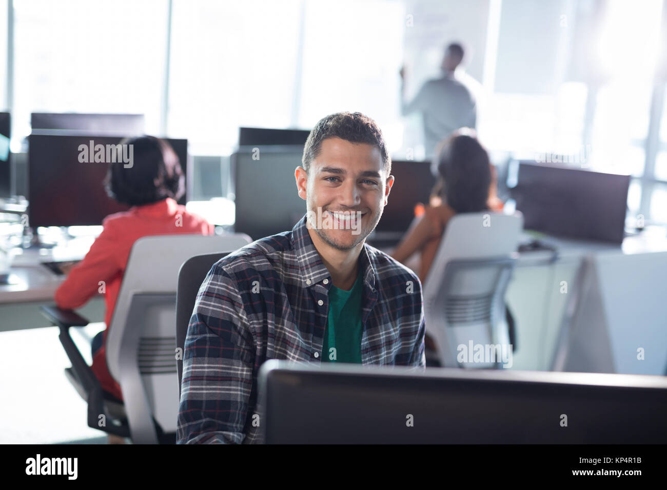 Portrait of male executive working on personal computer in office Stock ...