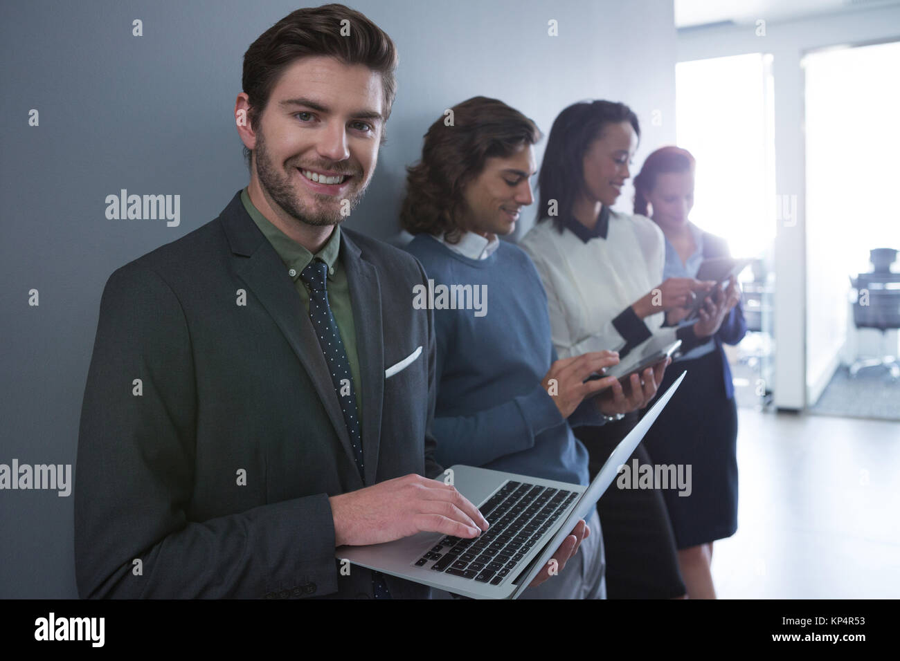 Team of business people using electronic devices in office Stock Photo ...