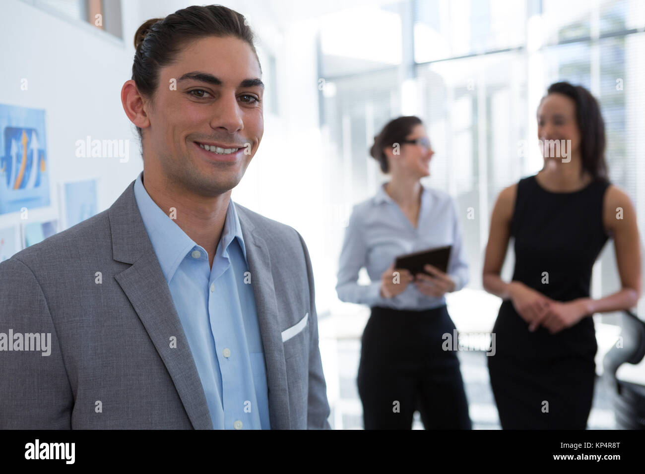 Smiling male executive looking at camera in the office Stock Photo - Alamy