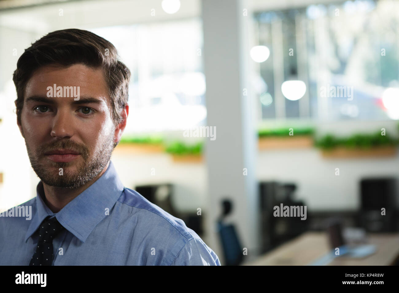 Confident male executive looking at camera in the office Stock Photo ...
