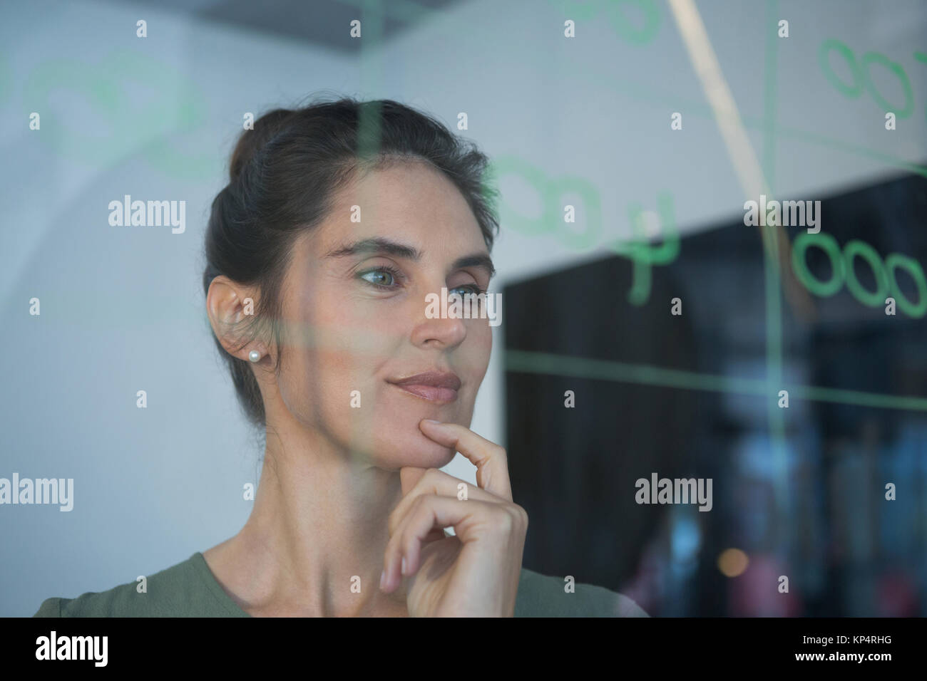 Female executive looking at graph in office Stock Photo - Alamy
