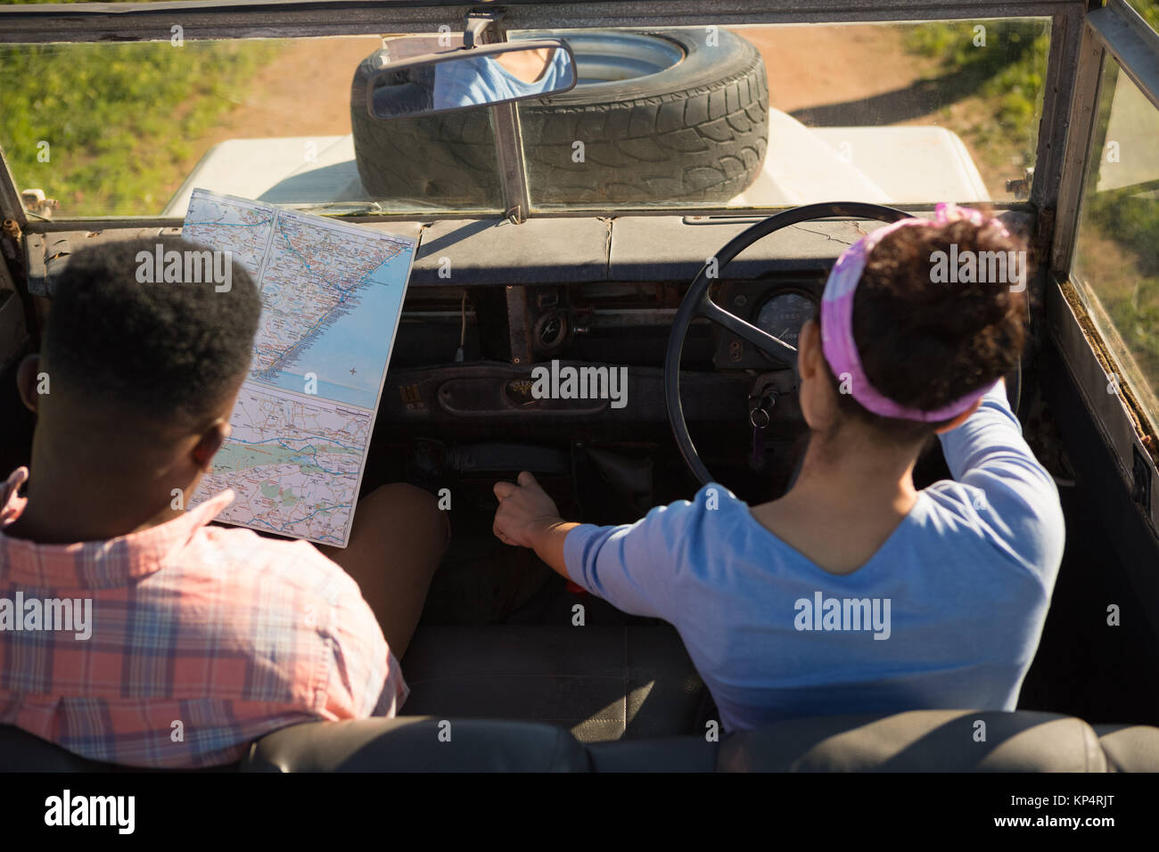 Couple looking at map while driving a car at countryside Stock Photo ...