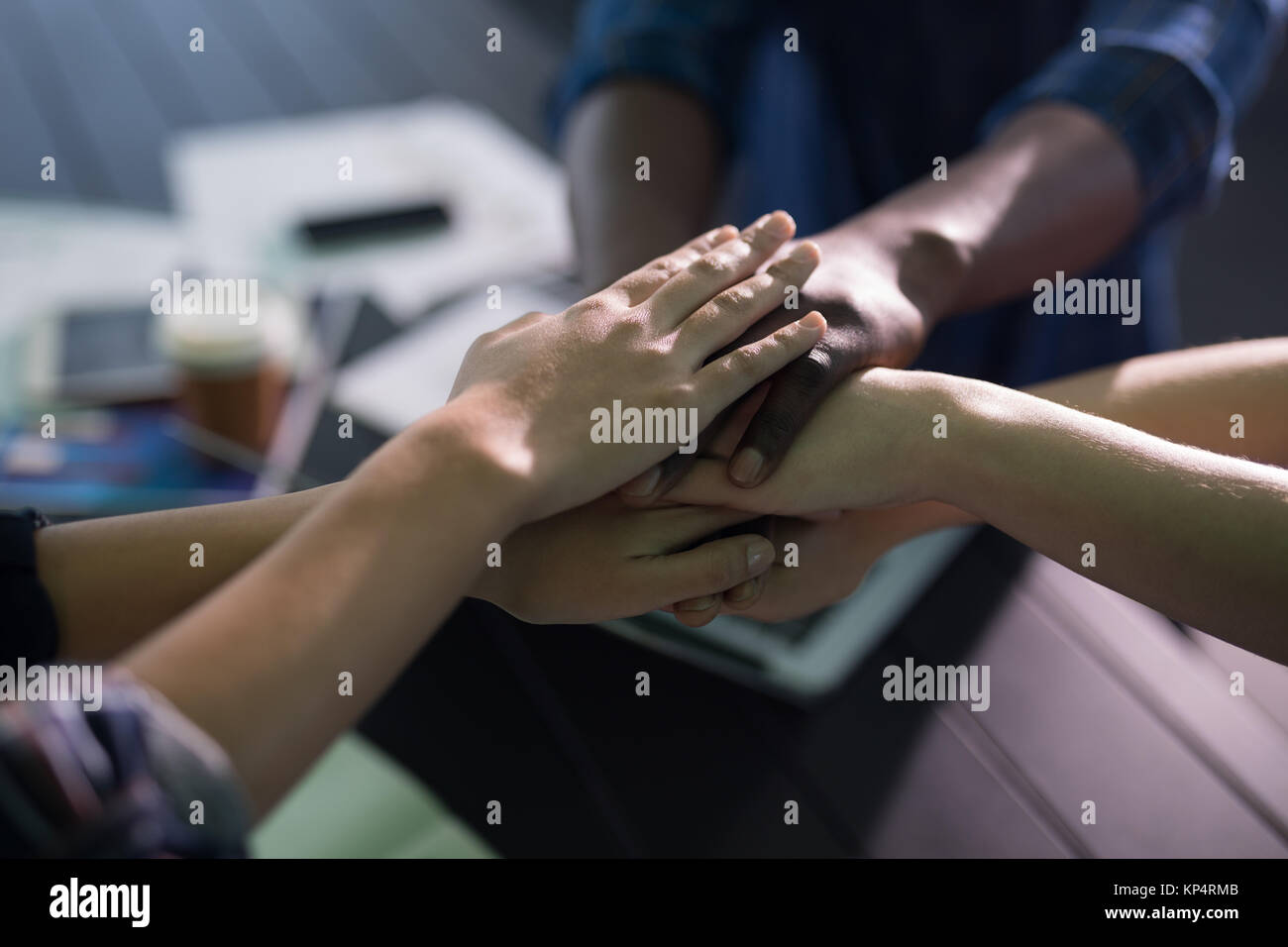 Close-up of business executives forming hand stack in futuristic office ...