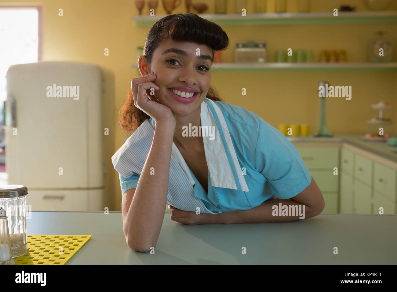 Waitress standing at counter in restaurant Stock Photo - Alamy