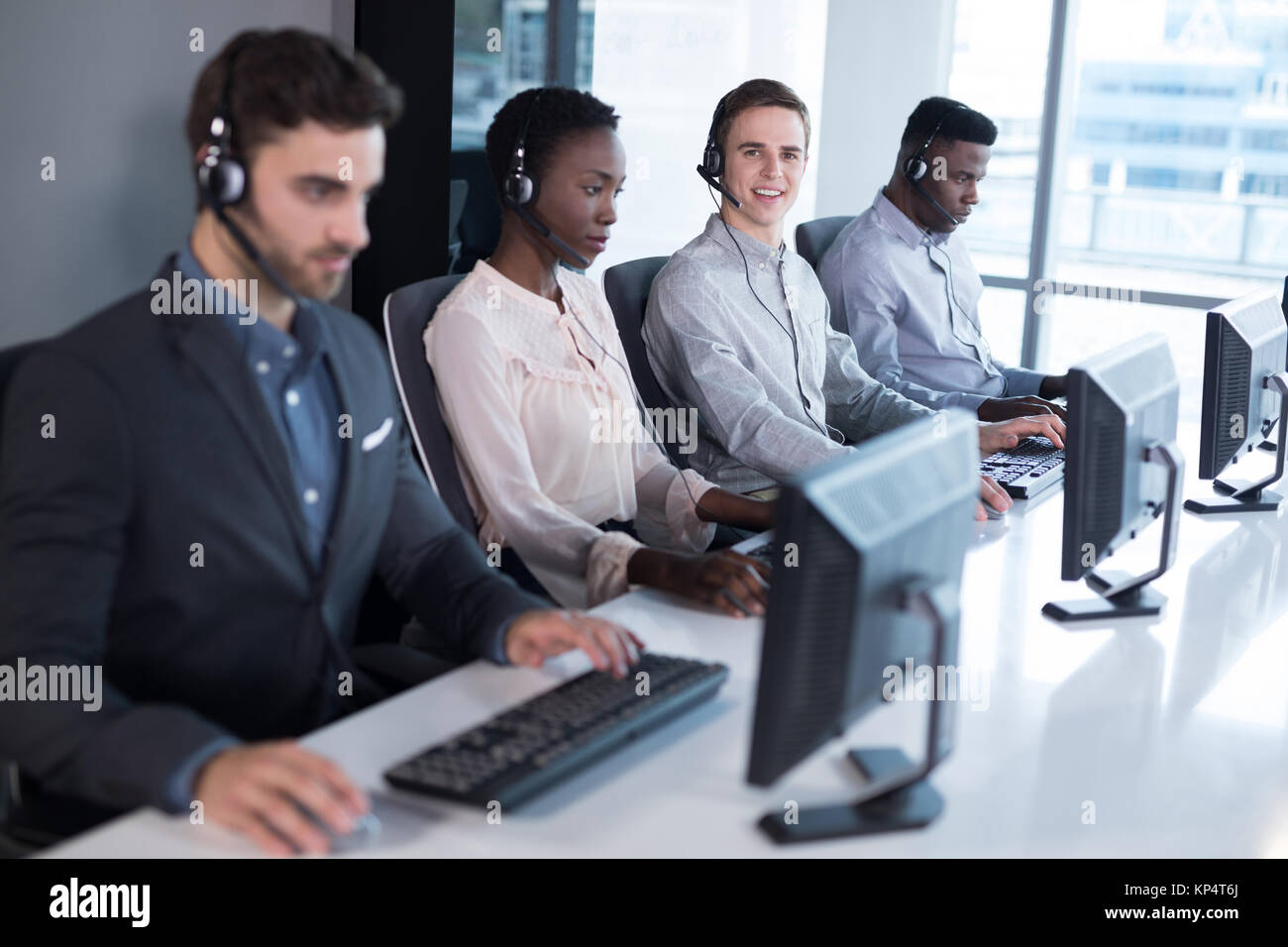 Portrait of customer service executives working at office Stock Photo ...