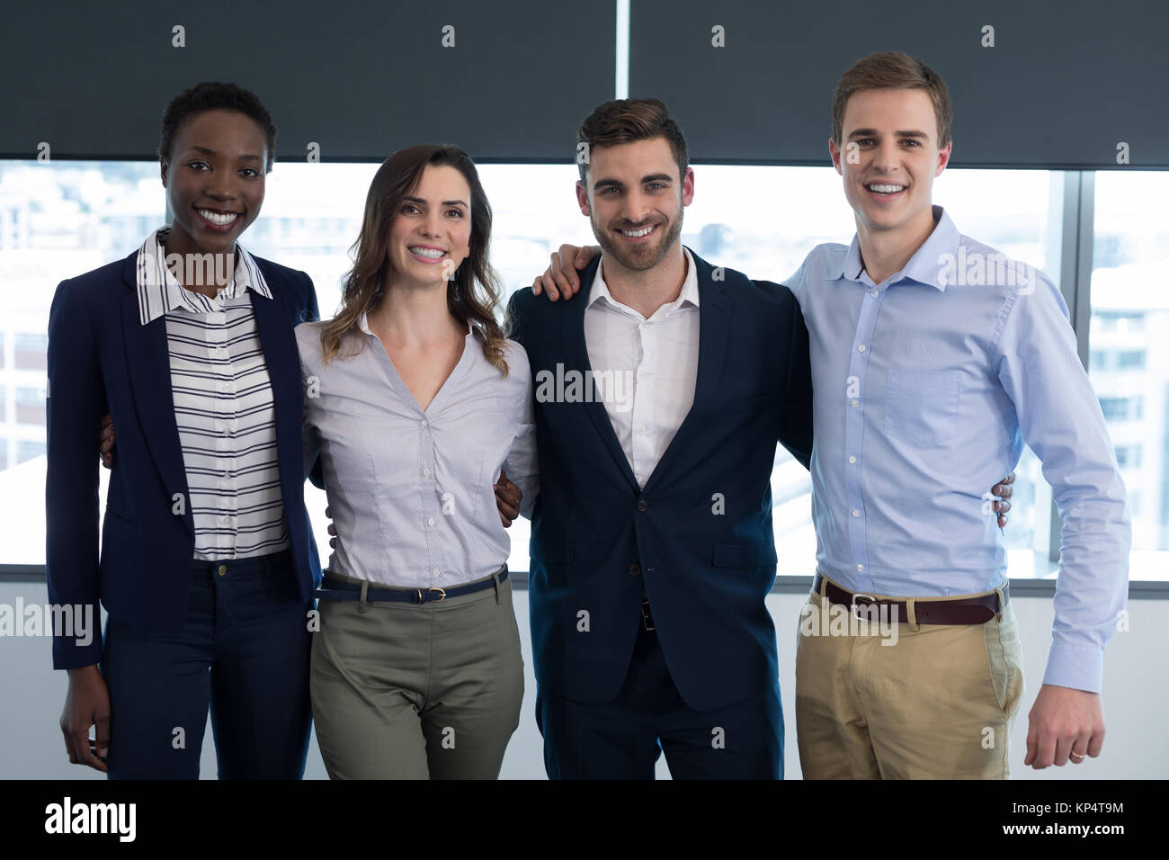 Portrait of confident executives standing together in office Stock ...