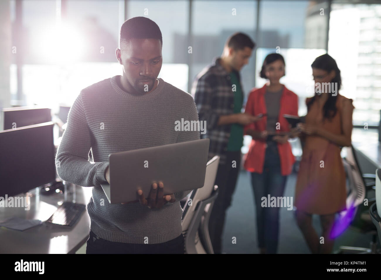 Attentive male executive using laptop in office Stock Photo - Alamy