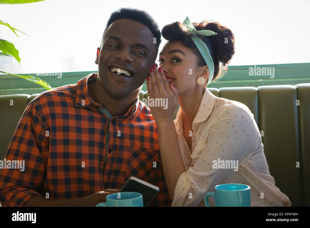 Woman whispering in ear of man hi-res stock photography and images - Alamy